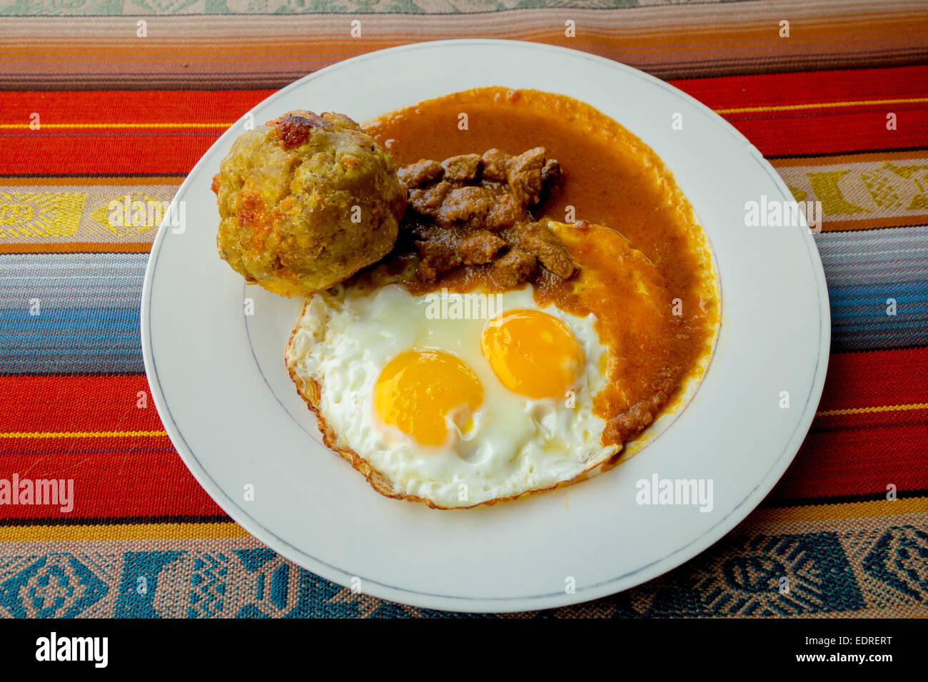 Bolon de verde with fried egg and meat stew ecuadorian food Stock Photo ...