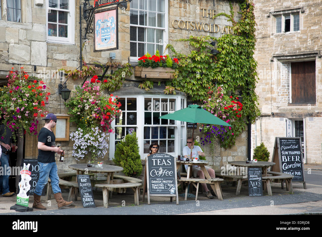Tourists at The Cotswolds Arms inn traditional old gastro pub in ...