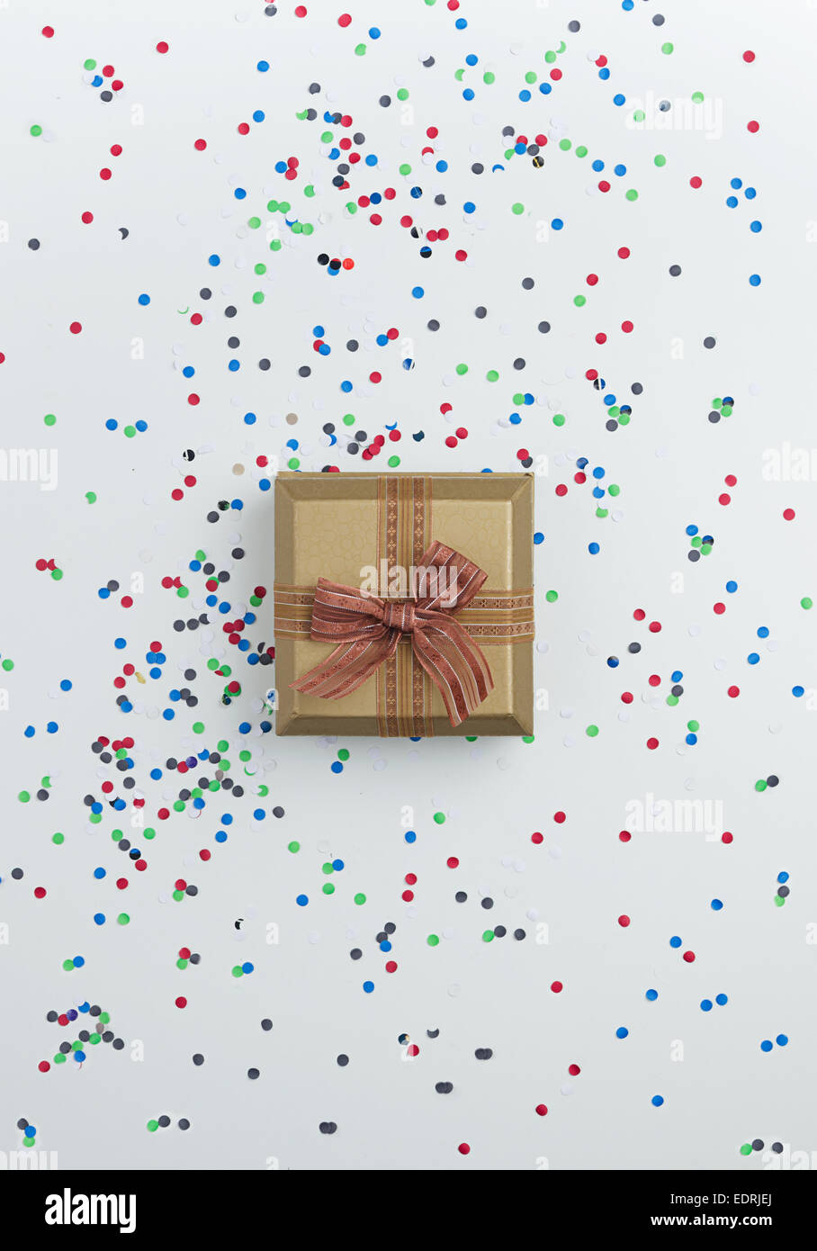 Gift box with confetti over white table Stock Photo - Alamy