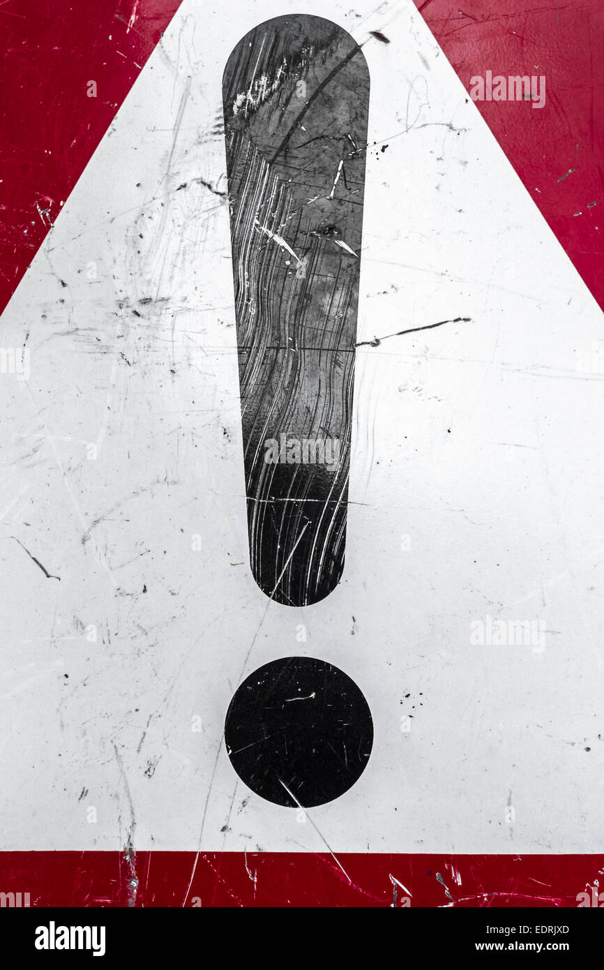 Extreme close-up of a warning sign with scratches and signs of wear ...