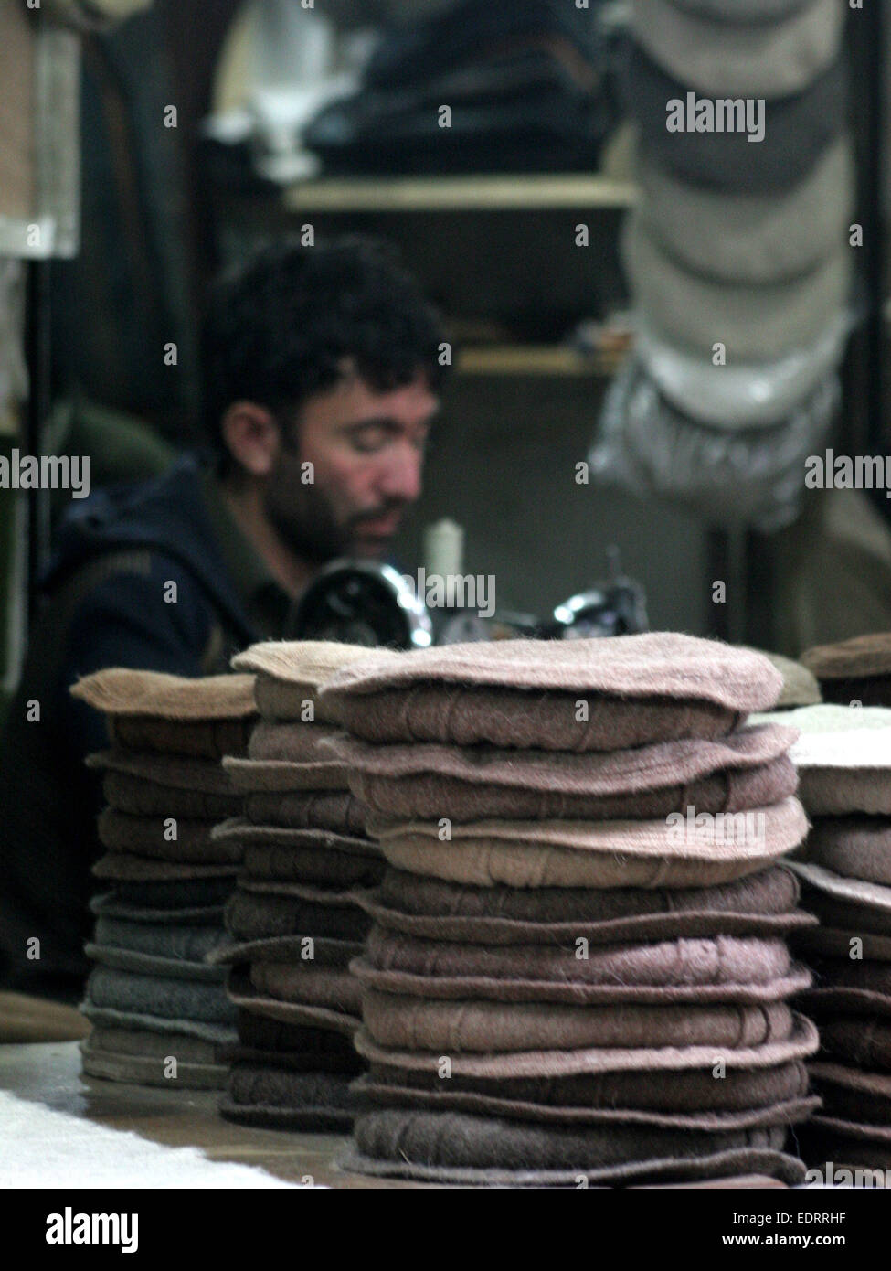 Peshawar. 9th Jan, 2015. A man knits a traditional cap inside a shop at ...