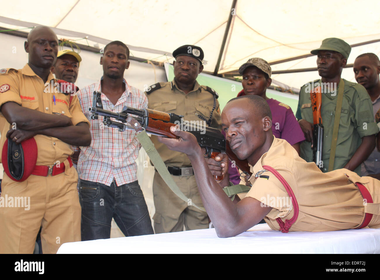 Members of Uganda security forces follow instructions during an ...