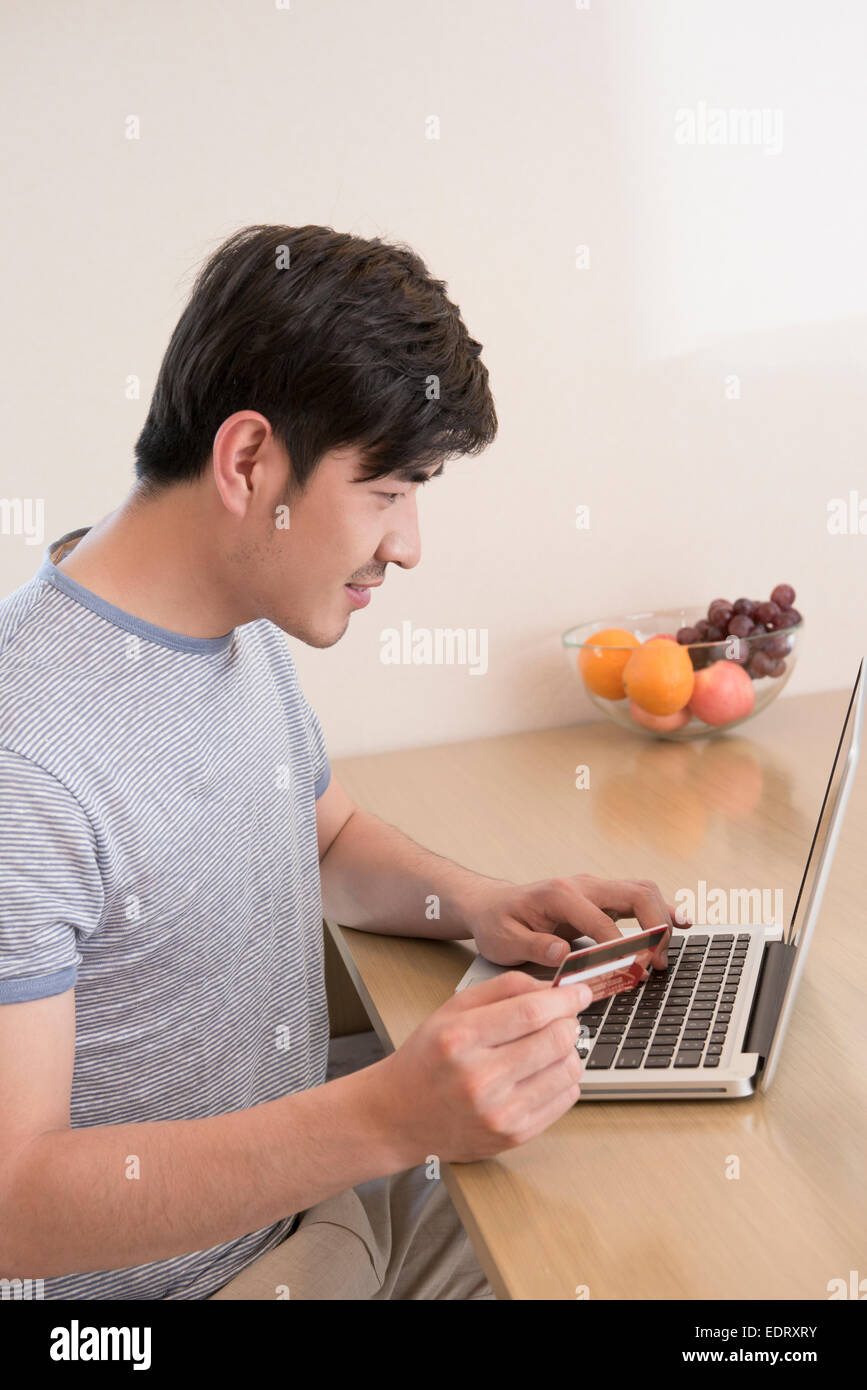 Young man shopping online Stock Photo - Alamy