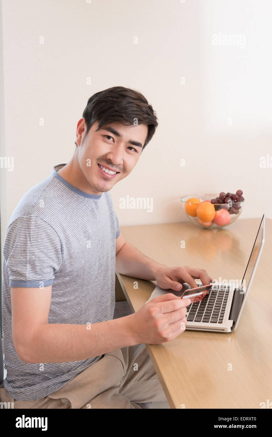 Young man shopping online Stock Photo - Alamy