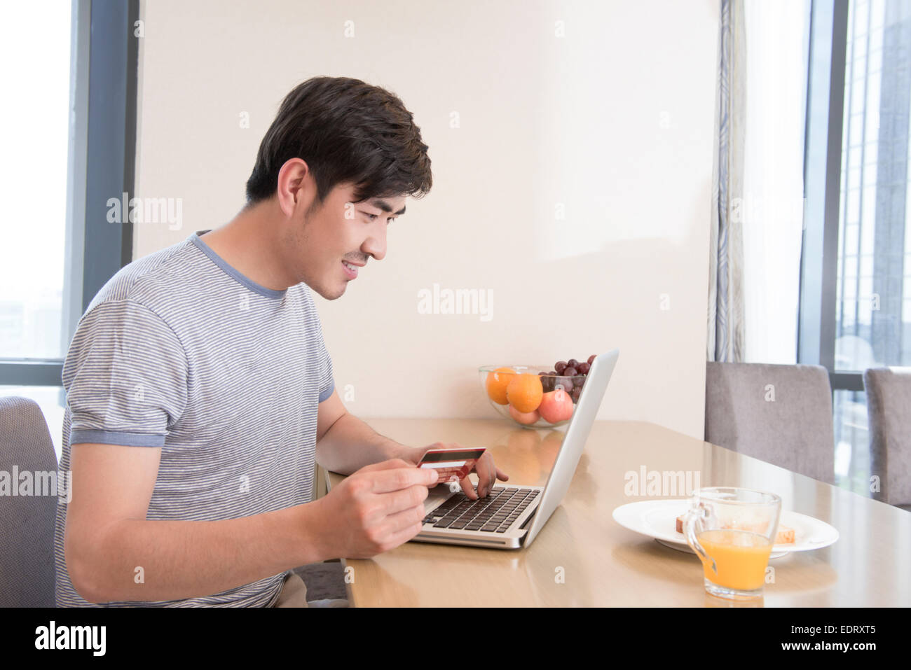 Young man shopping online Stock Photo - Alamy