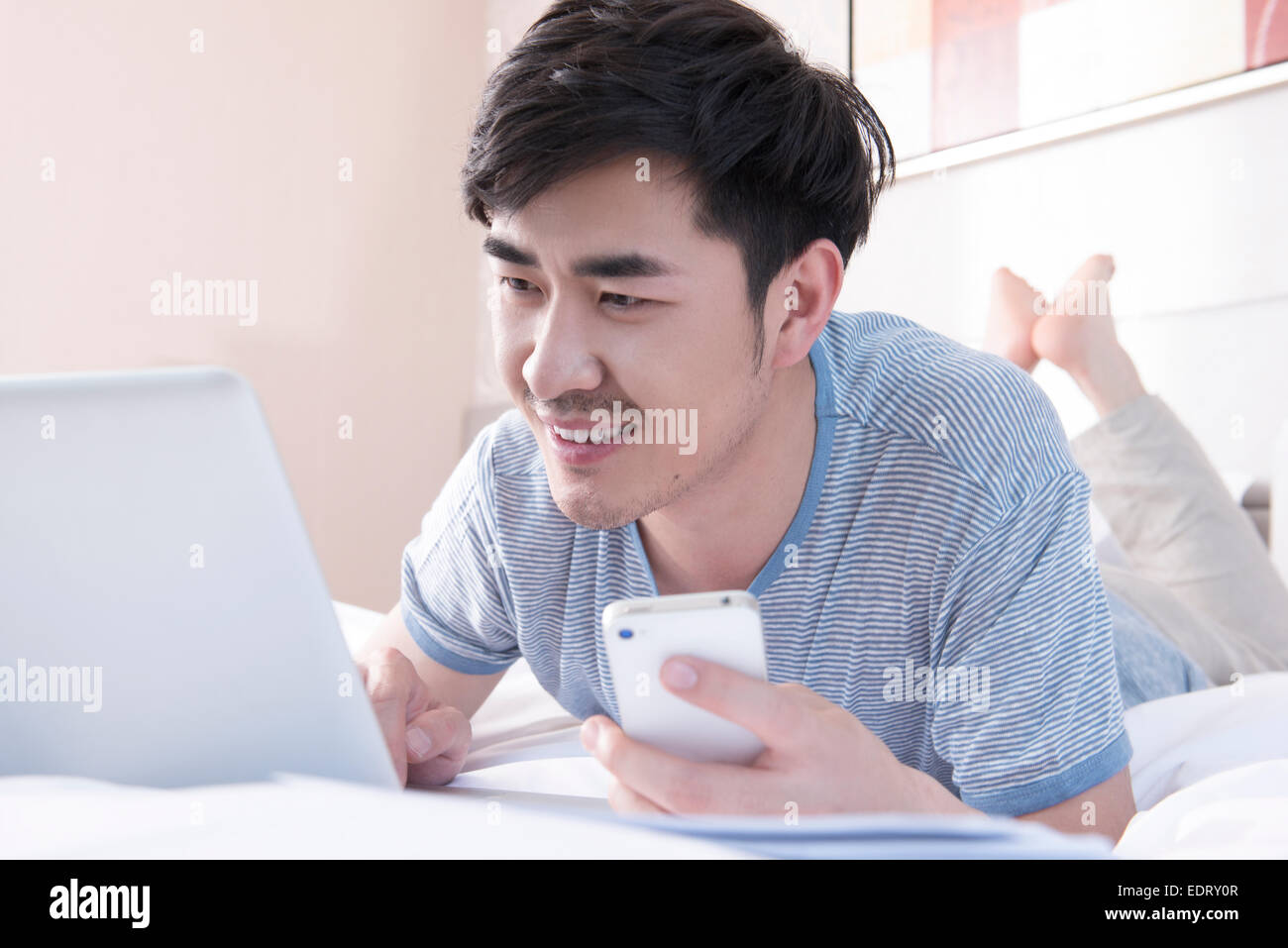 Working on computer in bed hi-res stock photography and images - Alamy