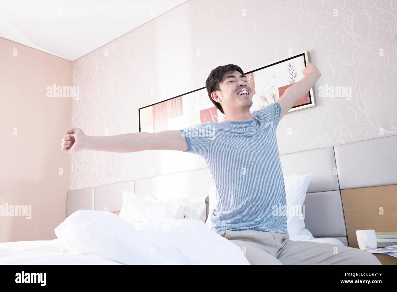 Young man waking up Stock Photo - Alamy