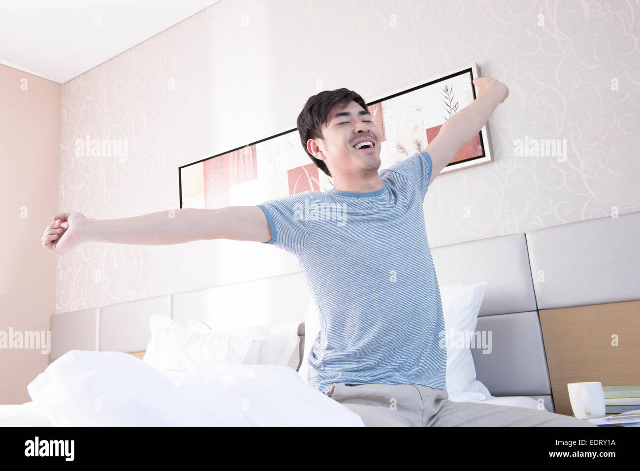 Young man waking up Stock Photo - Alamy