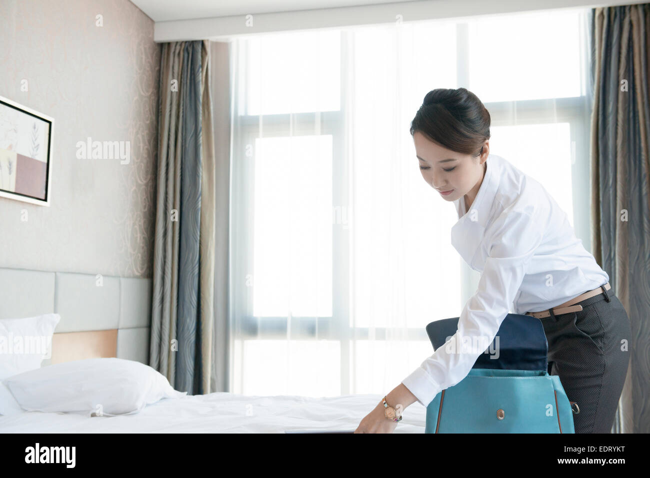 Young woman packing for work Stock Photo - Alamy