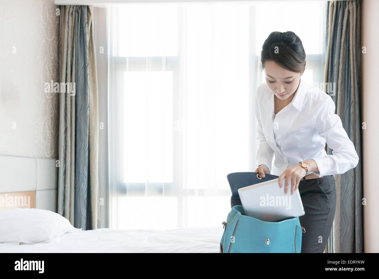 Young woman packing for work Stock Photo - Alamy