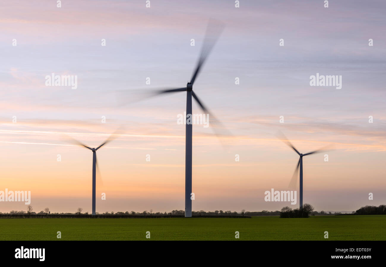 Modern wind turbines in field, previously RAF WW2 airfield, at sunset ...