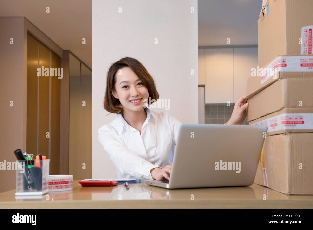 Online seller using laptop Stock Photo - Alamy