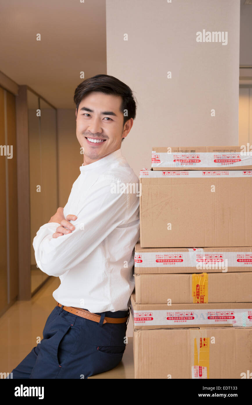 Asian man packing boxes hi-res stock photography and images - Alamy