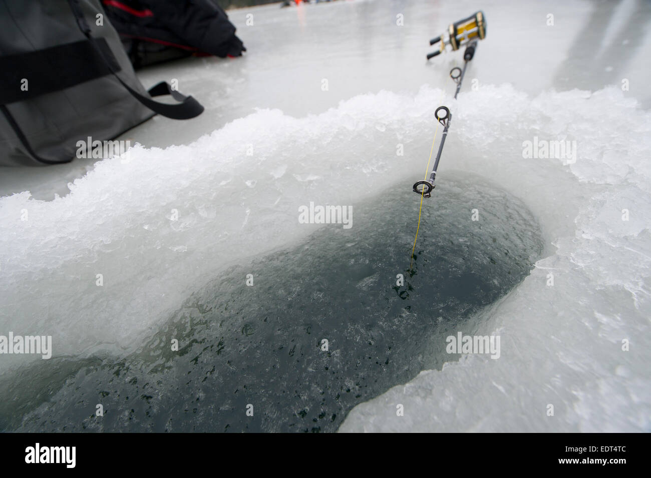 Ice fishing through an Ice Hole on a frozen lake near Trondheim in ...