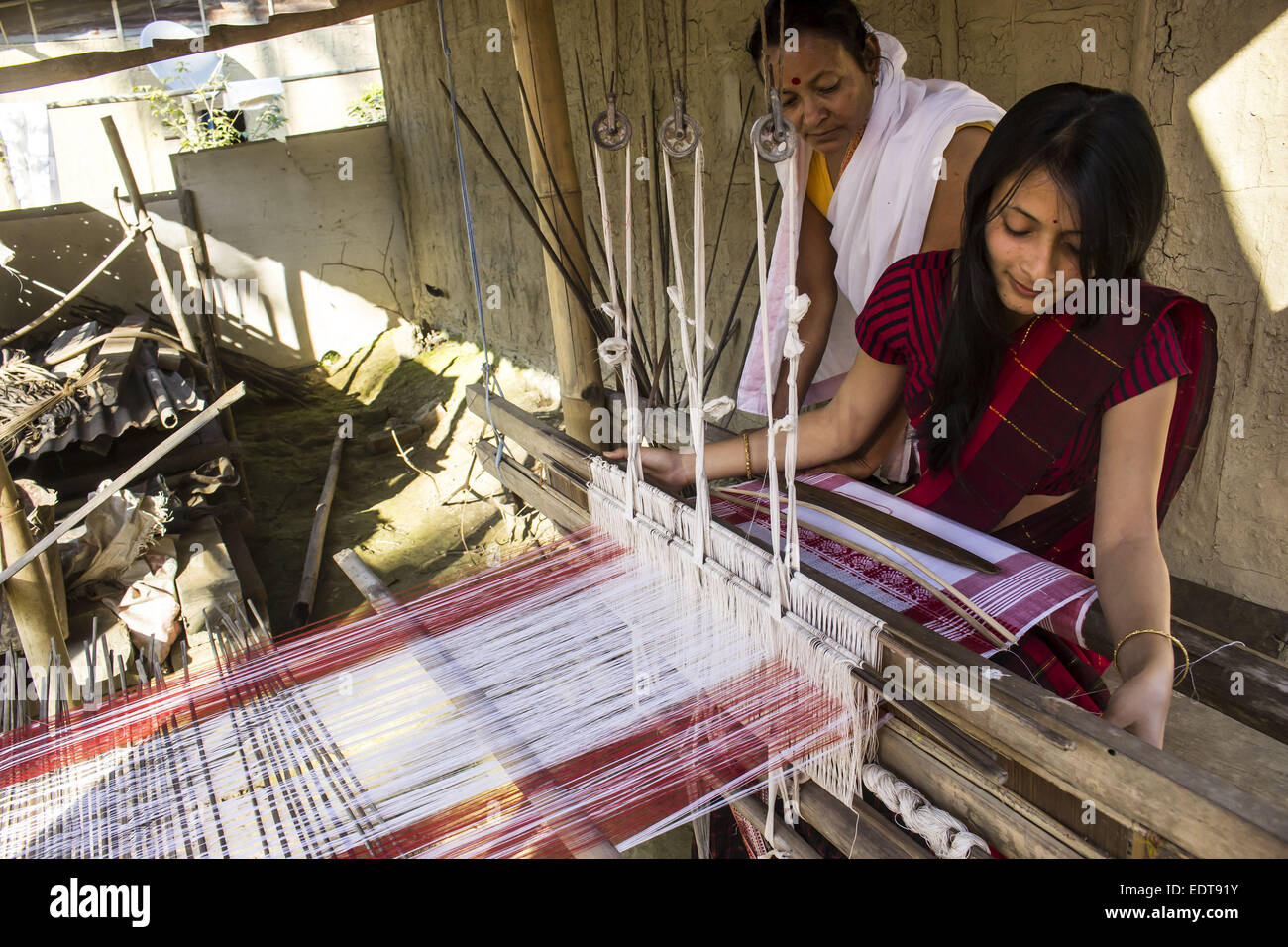 Sivasagar, Assam, India. 9th Jan, 2015. A girl weaves gamosa ...