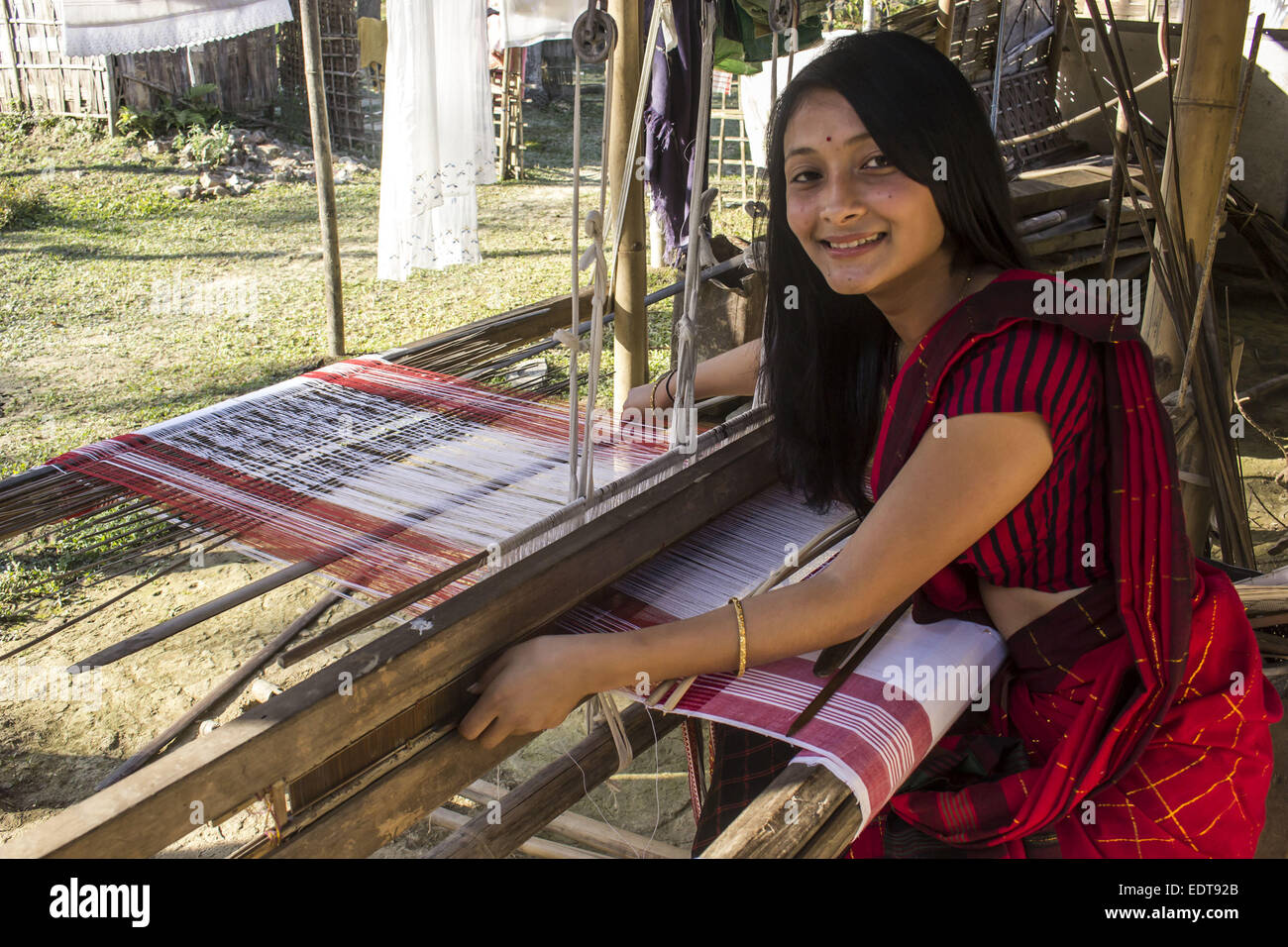 Sivasagar, Assam, India. 9th Jan, 2015. A girl weaves gamosa ...