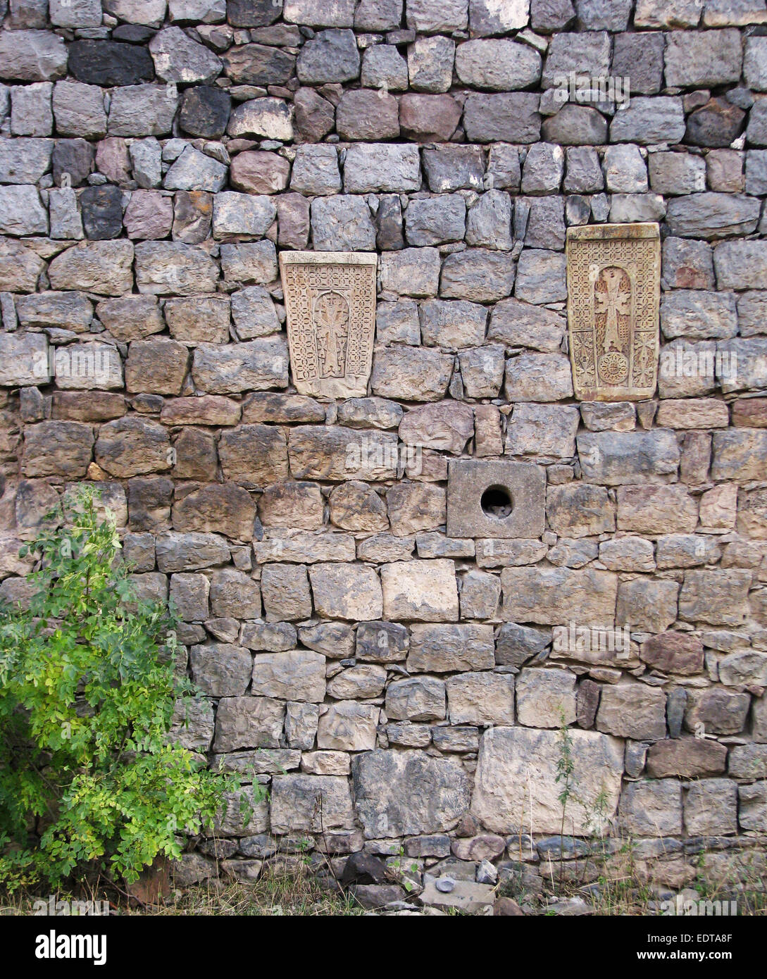 Small cross-stones on a wall Stock Photo - Alamy