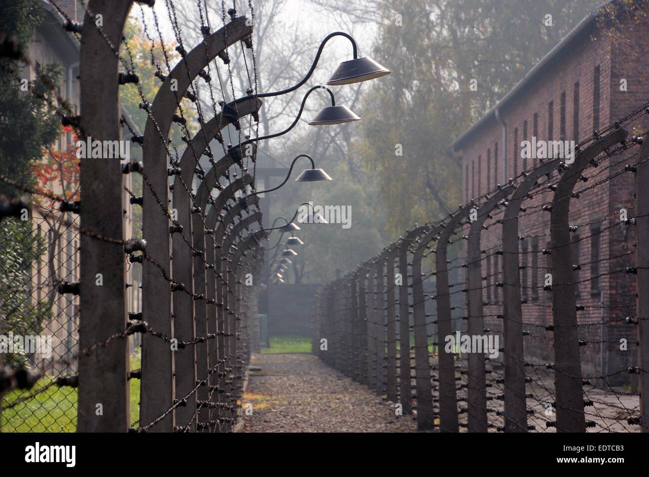 A double barbed wired fence surrounds the main camp of Auschwitz ...