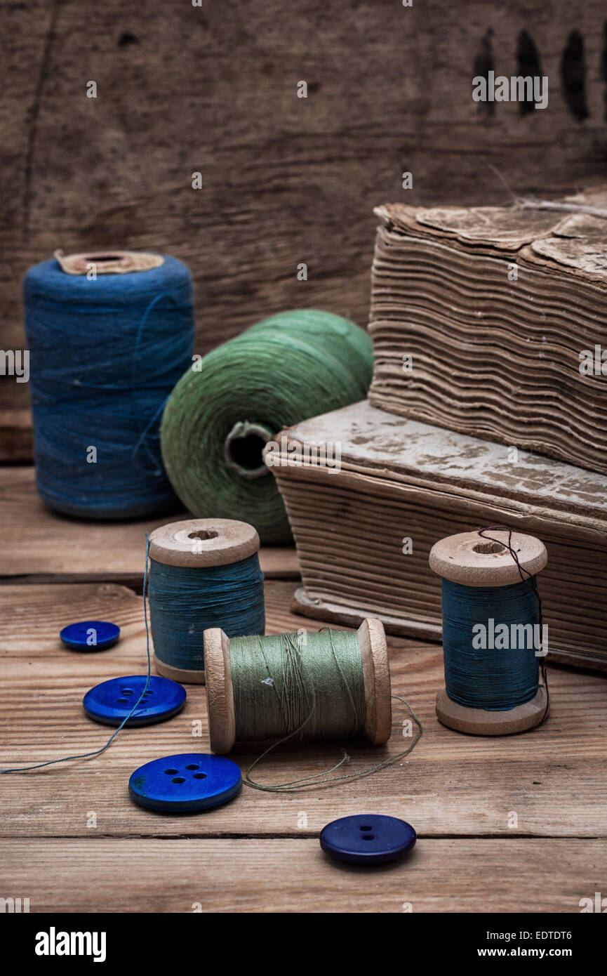 spool sewing thread and buttons in vintage style Stock Photo - Alamy