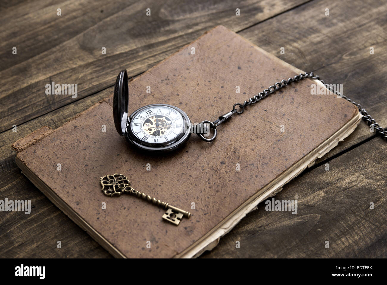 Antique book and pocket watch on grunge wooden table, close up Stock ...