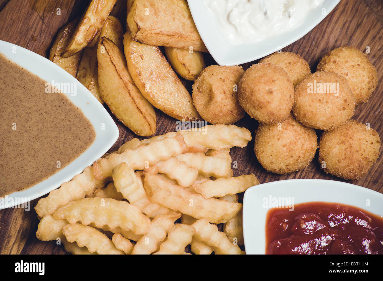 snack potato platter with dips on wooden board Stock Photo - Alamy