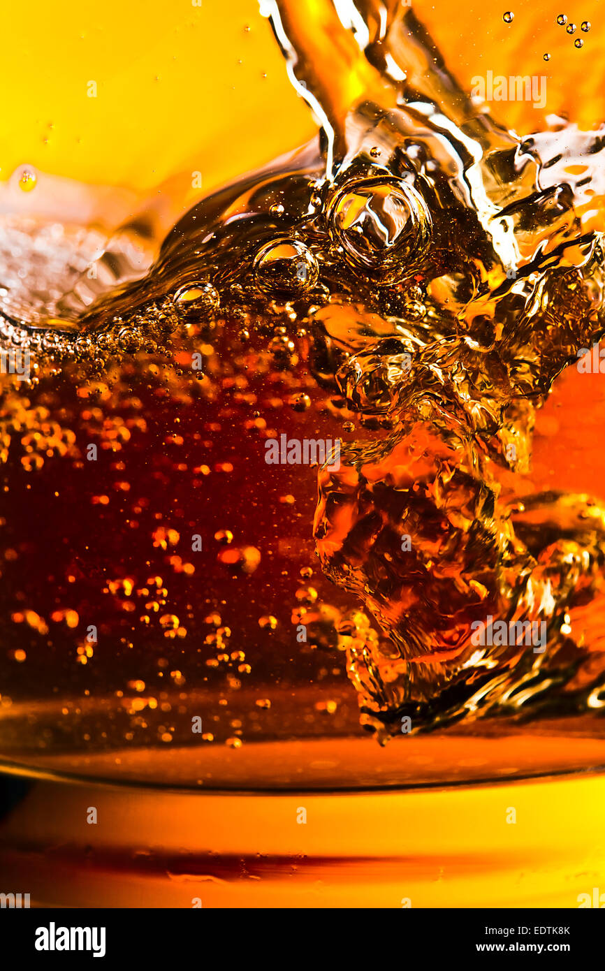 detail of an alcoholic beverage on yellow background Stock Photo - Alamy