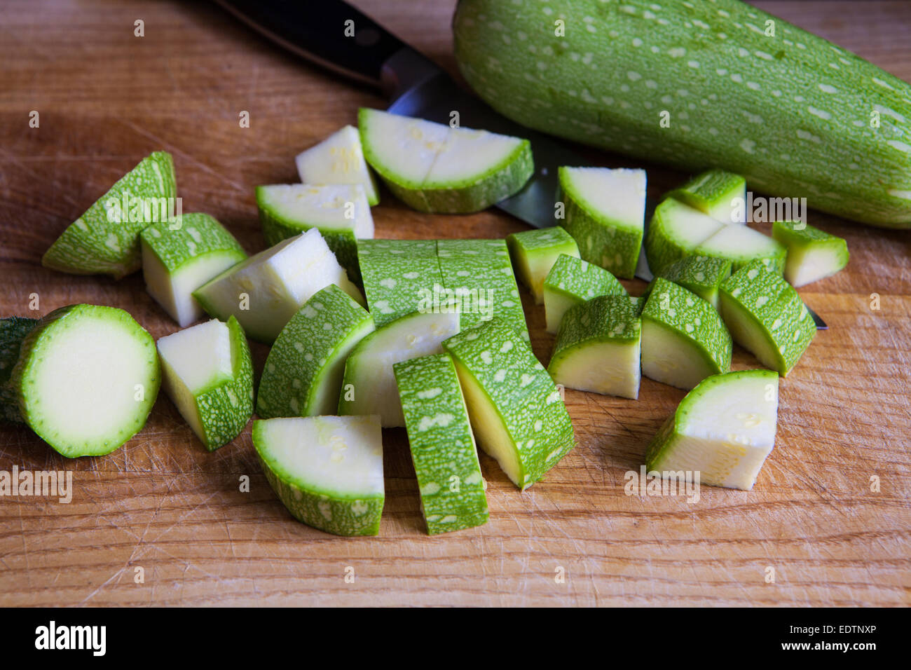cutting marrow in pieces on wood table for cooking Stock Photo - Alamy