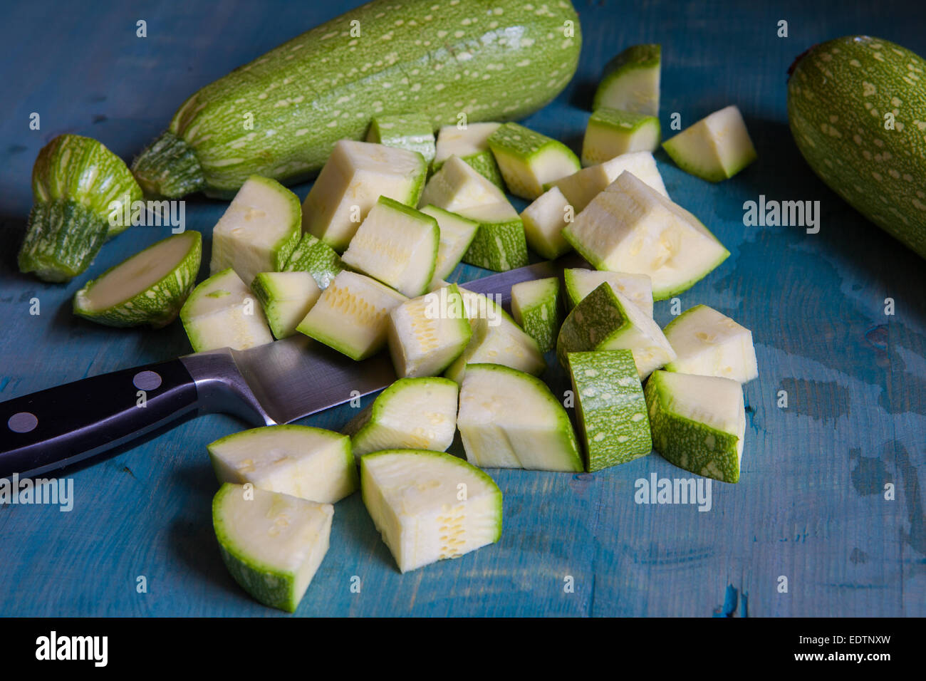 cutting marrow in pieces on wood table for cooking Stock Photo - Alamy