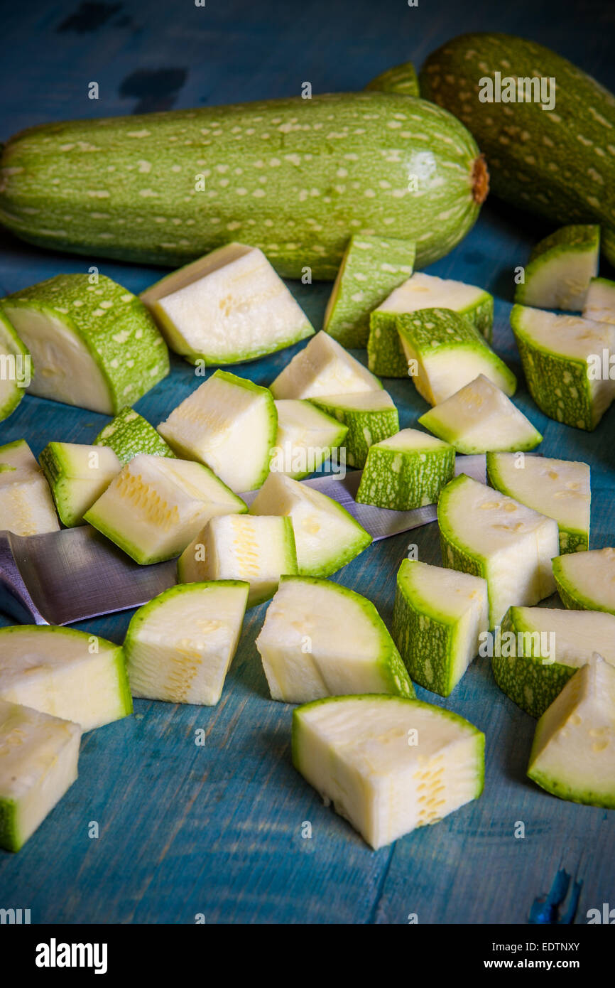 cutting marrow in pieces on wood table for cooking Stock Photo - Alamy