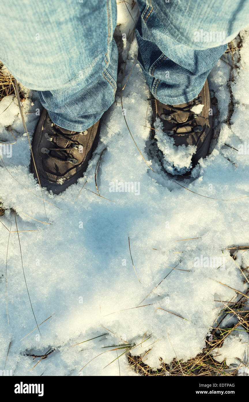 Brown boots covered in snow walking on a snowy field Stock Photo - Alamy