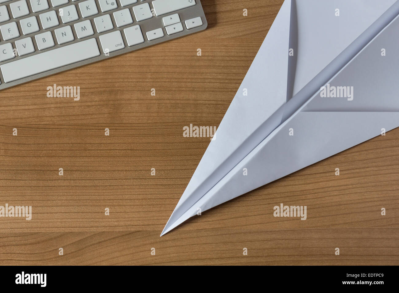 Paper Airplane on a wooden office desk with modern keyboard Stock Photo ...