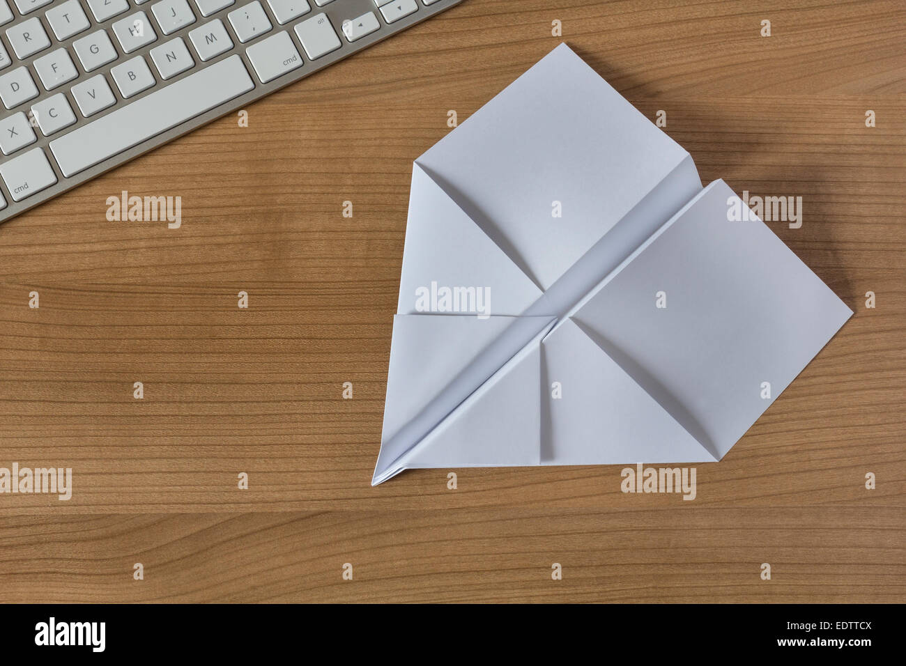 Paper Airplane on a wooden office desk with modern keyboard Stock Photo ...