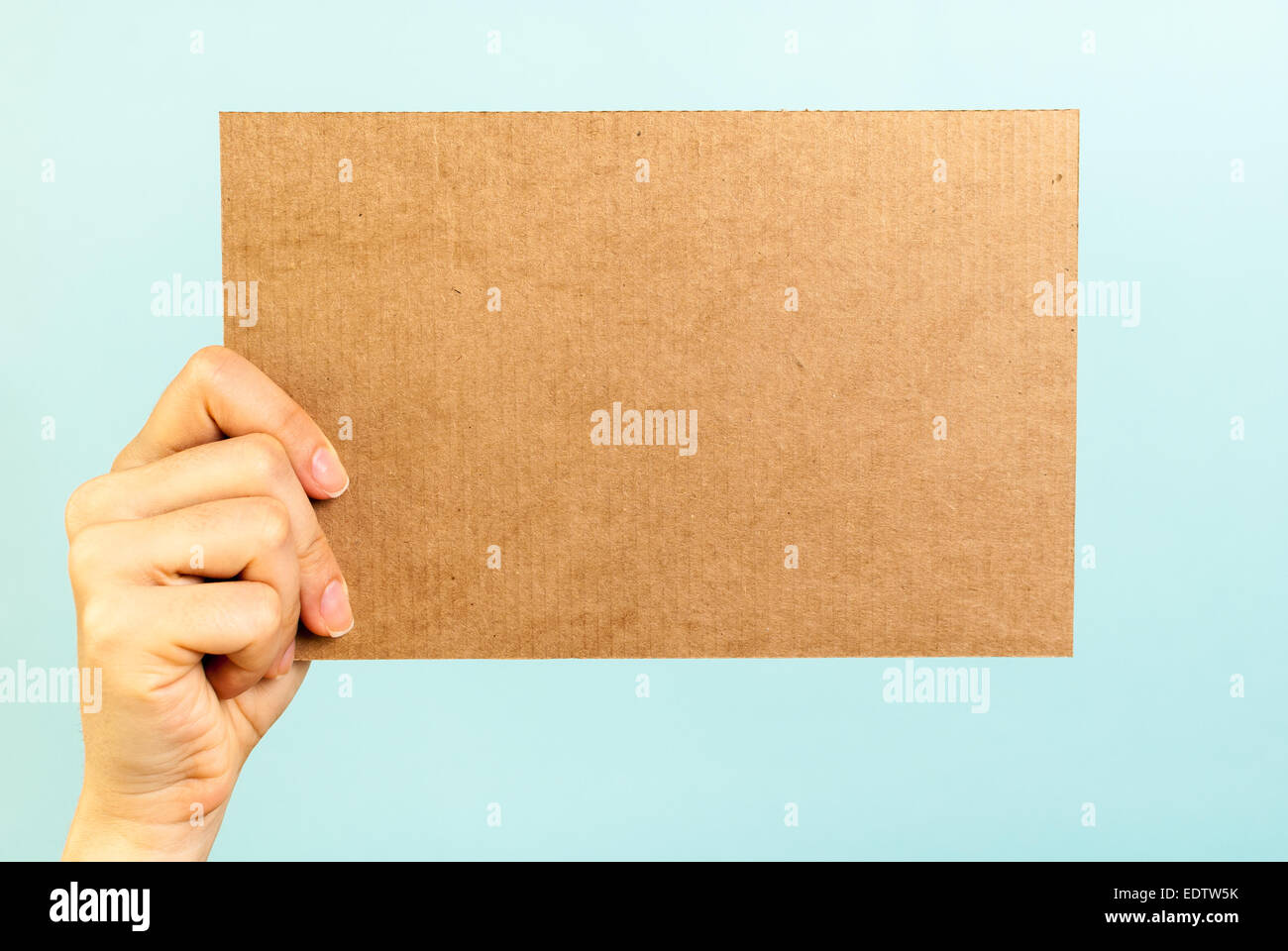 Right hand showing a blank cardboard message Stock Photo - Alamy