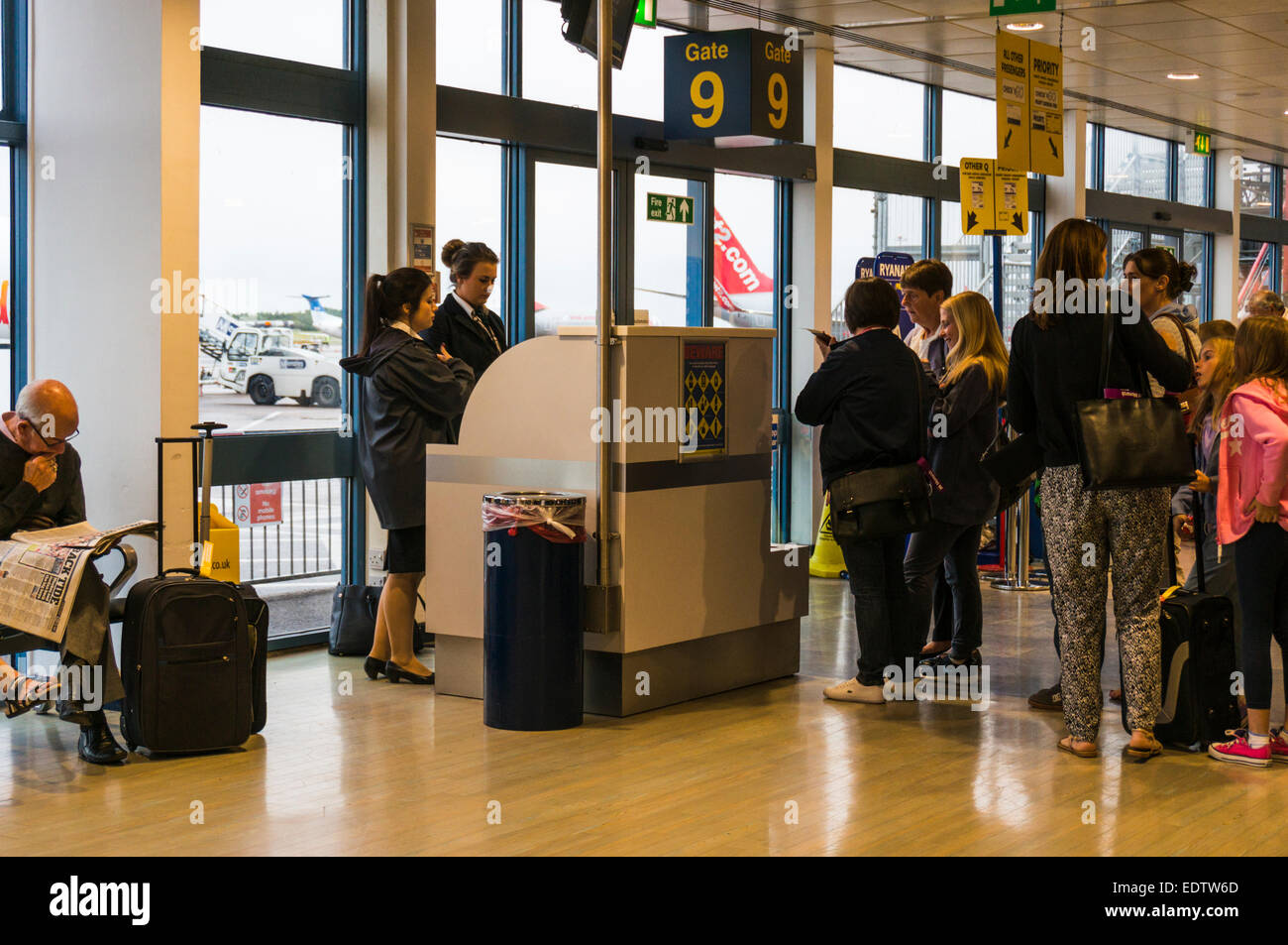 Families queueing to pass through the departure gates and join their ...