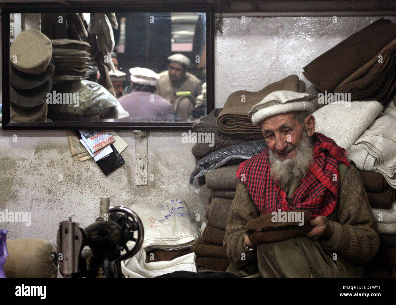Peshawar. 9th Jan, 2015. A craftsman knits a traditional cap at a ...