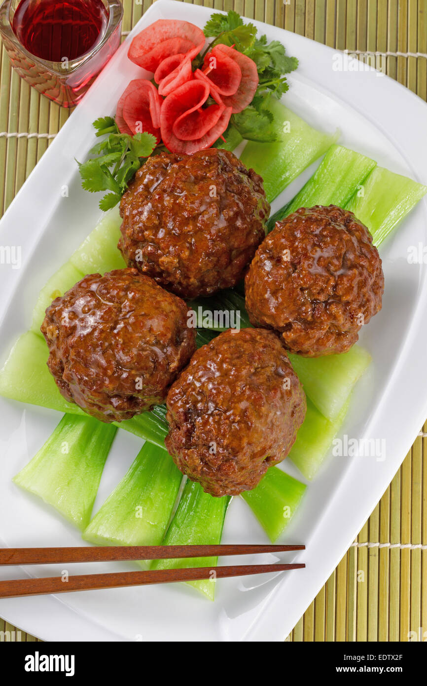 Top view close up vertical image of large freshly cooked meatballs and ...