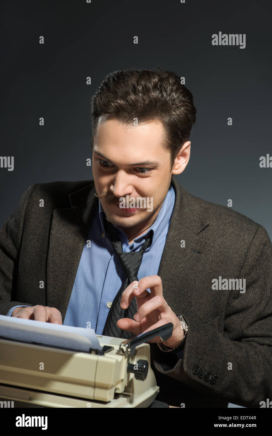 Inspired author working at the typewriter Stock Photo - Alamy