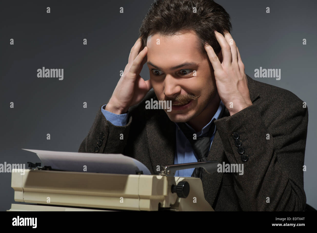 Inspired author working at the typewriter Stock Photo - Alamy
