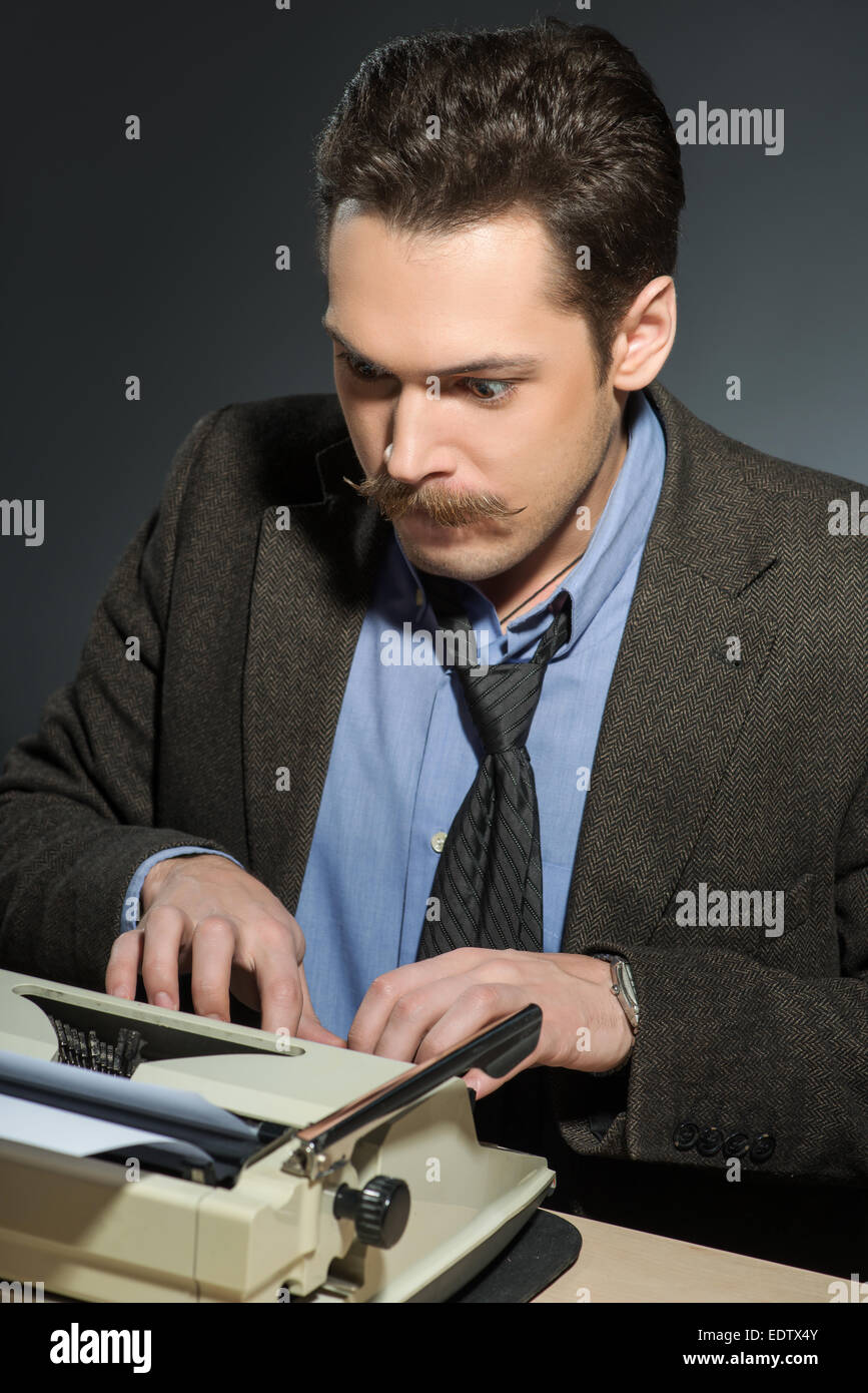 Inspired author working at the typewriter Stock Photo - Alamy