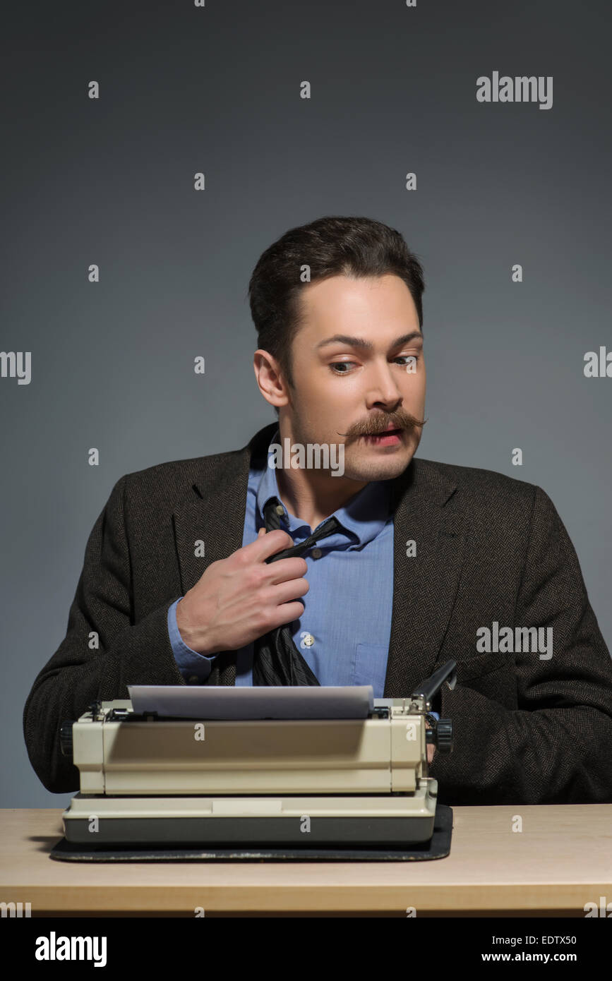 Inspired author working at the typewriter Stock Photo - Alamy