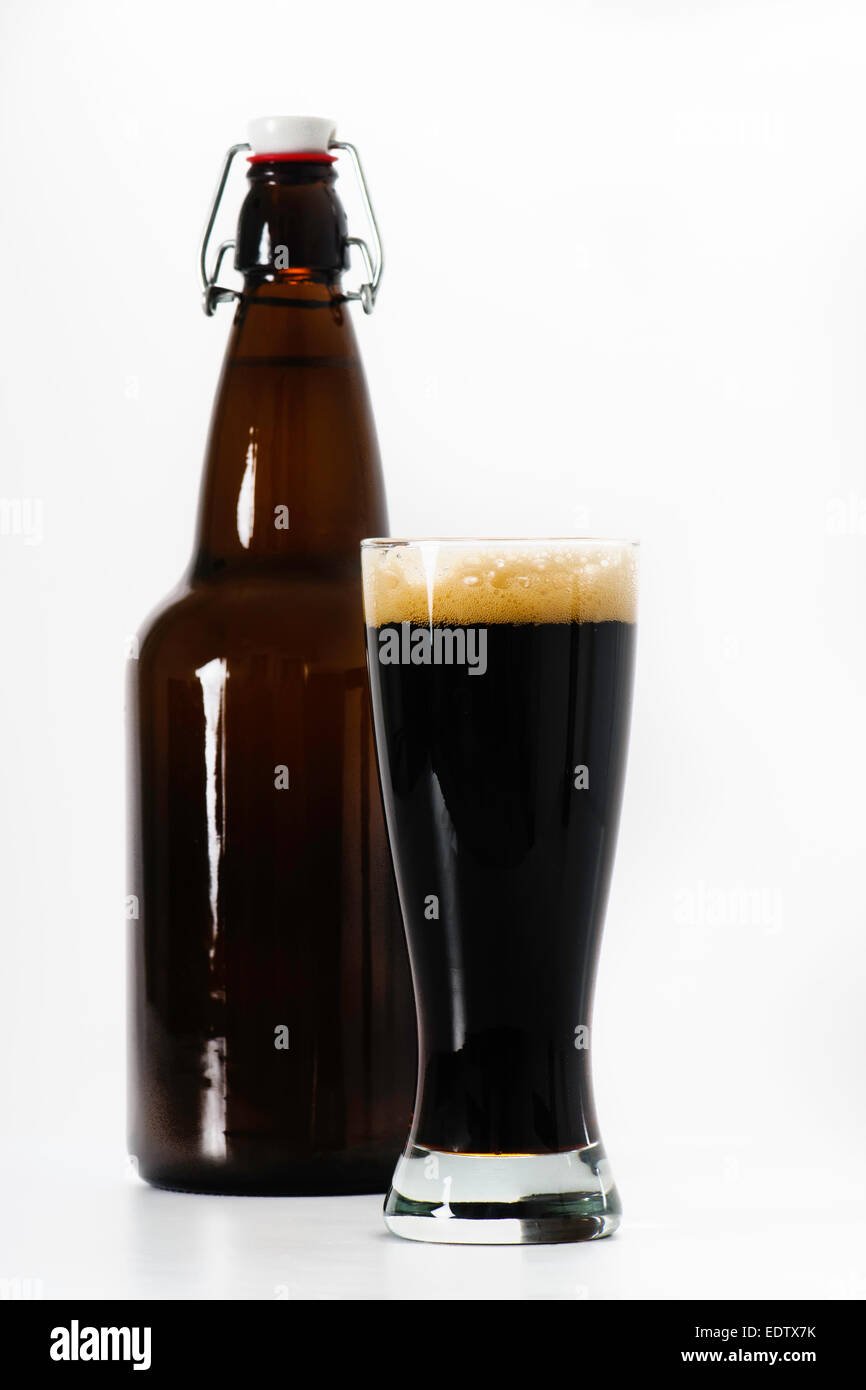 Dark Stout beer with bottle on white Stock Photo - Alamy