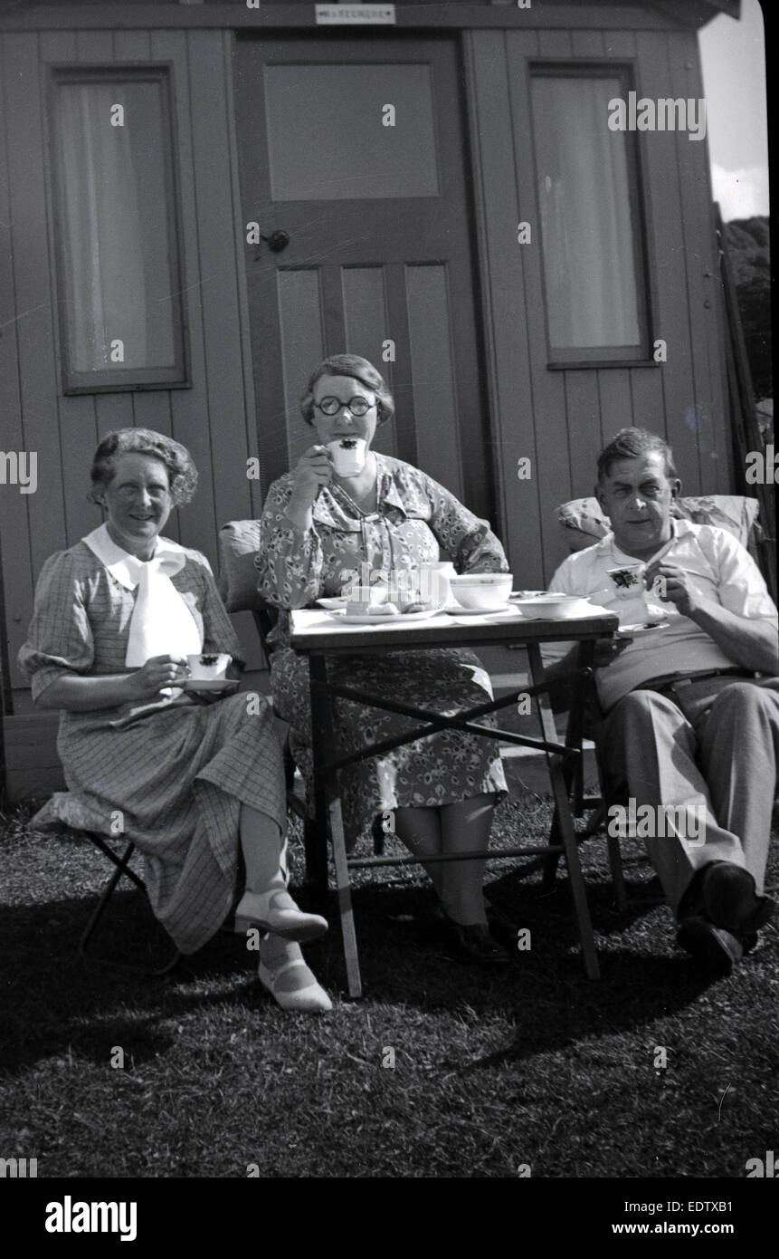 1930s, historical, two ladies and a gentleman having tea together on ...