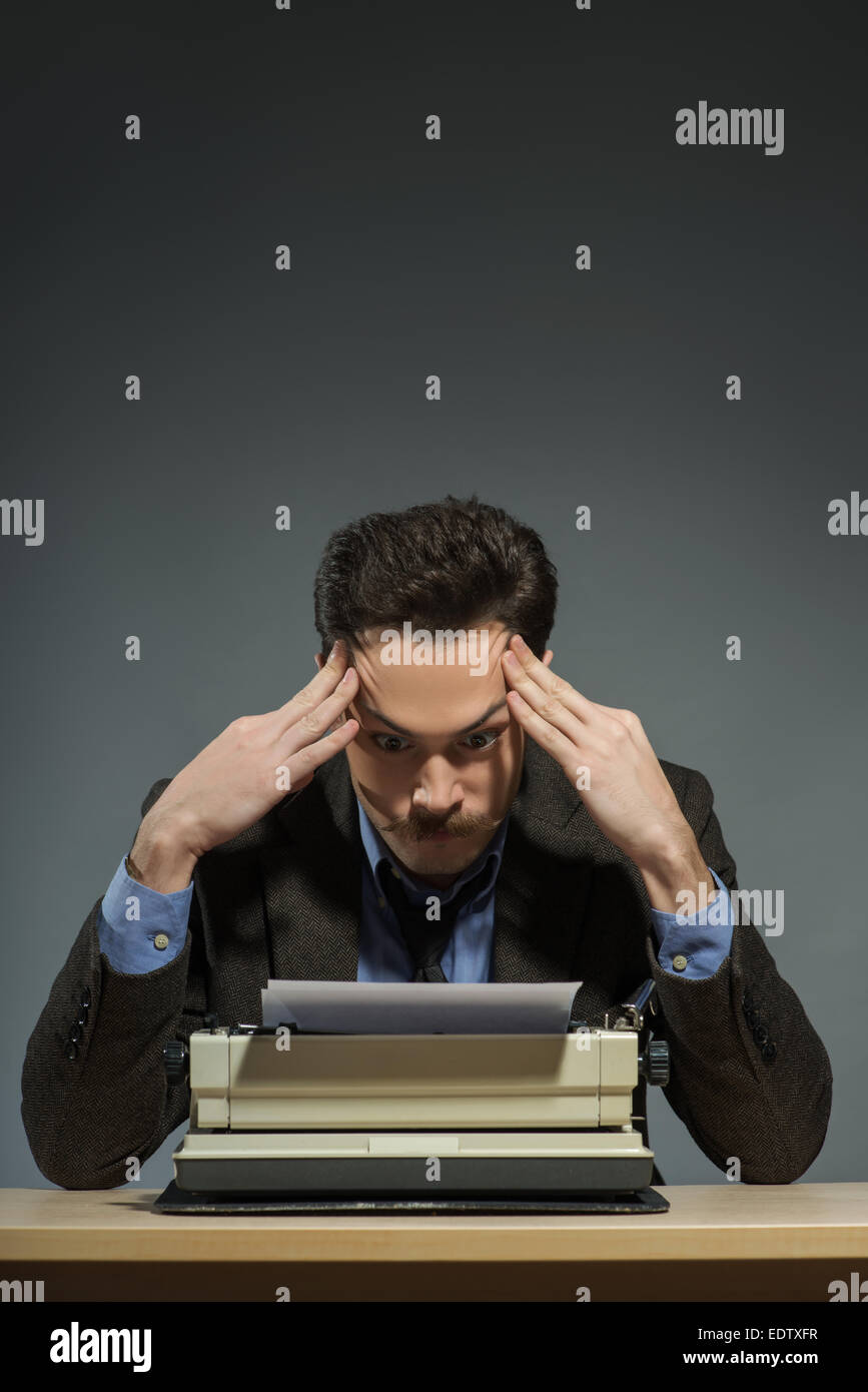 Inspired author working at the typewriter Stock Photo - Alamy