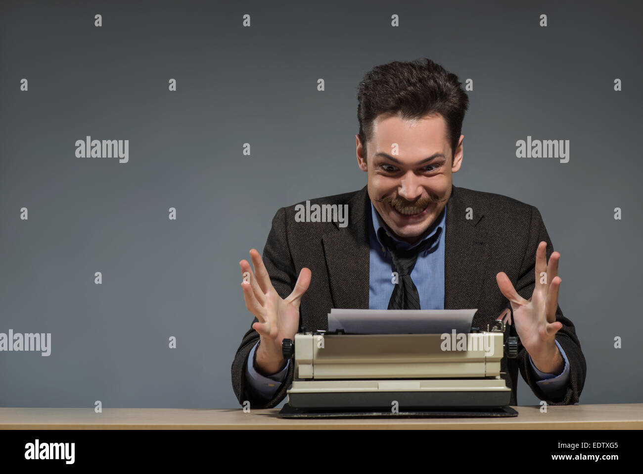 Inspired author working at the typewriter Stock Photo - Alamy