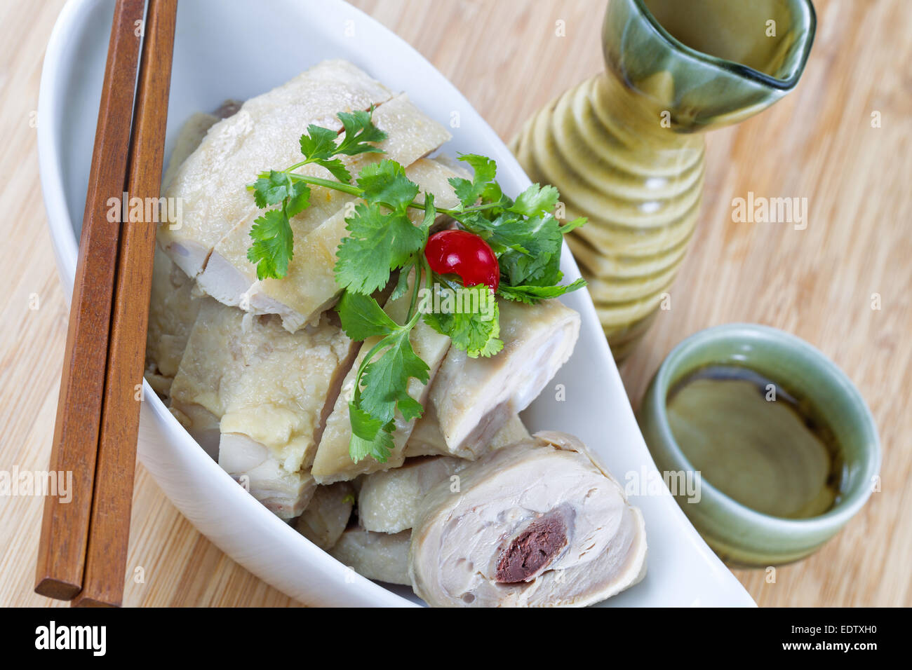 Close up angled view of Chinese sliced cooked chicken in white bowl ...