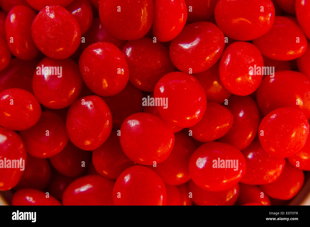 A pile of red cinnamon candies sets the stage for a sweet background ...