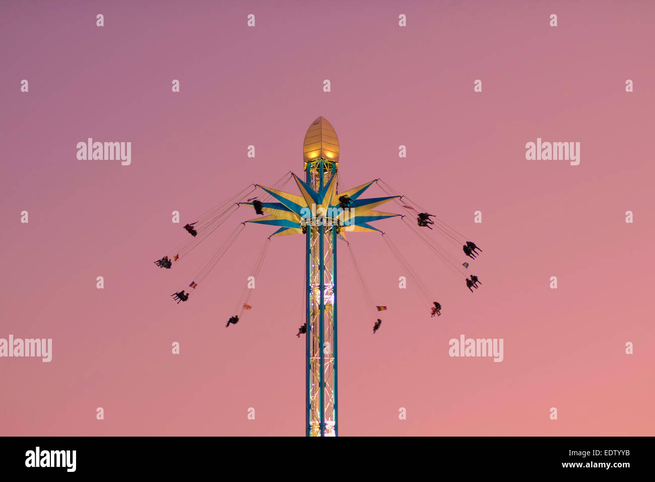 people riding on a high spinning swing ride at Winter Wonderland ...