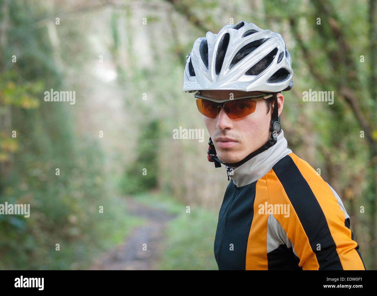 Cyclist portrait in a path of the forest Stock Photo - Alamy