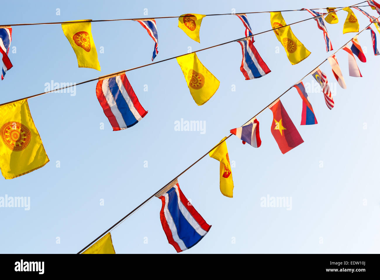 National flags and Wheel of Dhamma 's flags on string and blue sky at ...