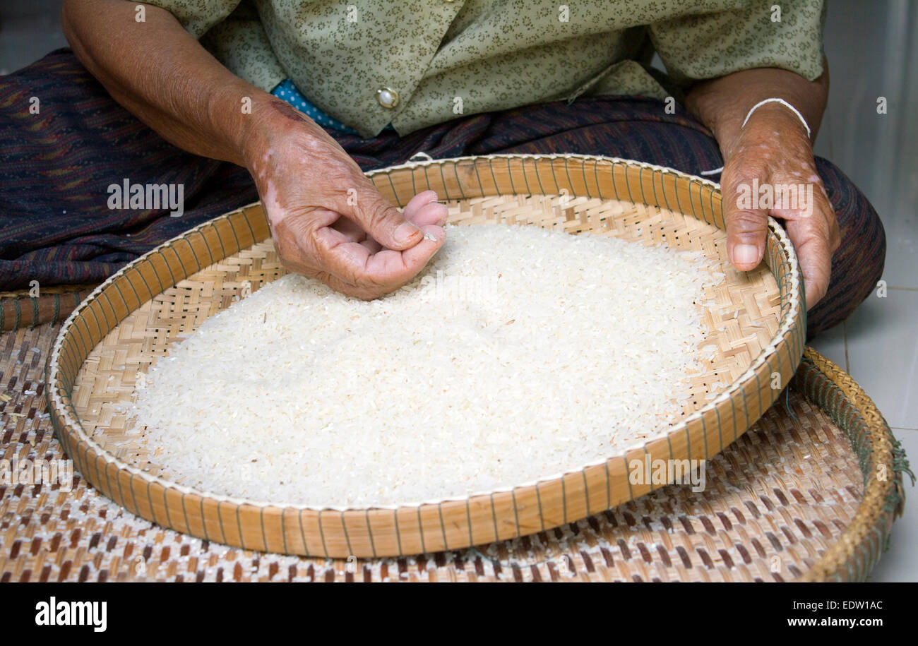 winnow jasmine rice by hand on basket Stock Photo - Alamy